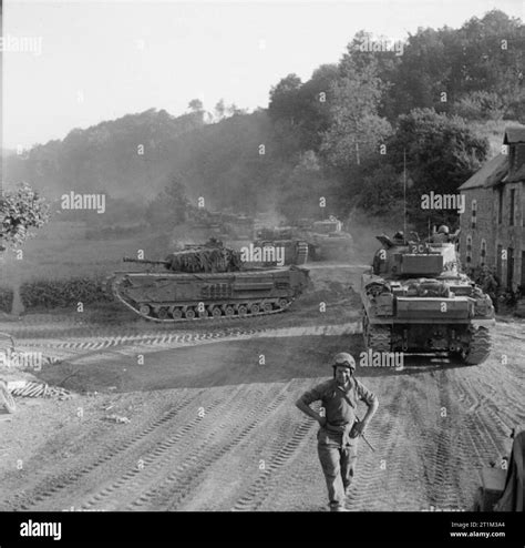 The British Army In Normandy 1944 Churchill And Sherman Tanks Pass Each