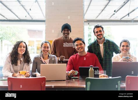 Smiling Multiethnic Coworkers Looking At Camera Making Team Picture In