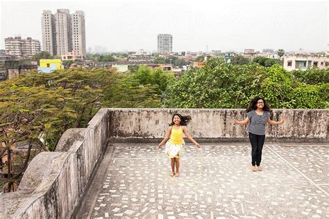 Two Sisters Exercising At The Rooftop With Jumping Rope By Stocksy
