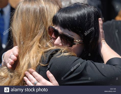 Meta Mitchell Daughter Of The Late Jim Mitchell Gets A Hug From A Friend During A Memorial