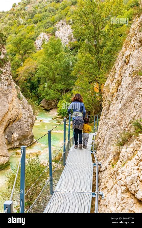 Woman And Son Walking Along The Metal Walkways Of The Vero River Path In Alquezar Pyrenees