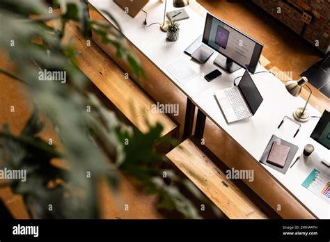 A Modern Casual Business Office Setup Features A Clean Desk With Tech