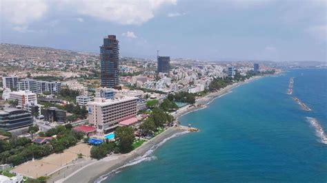 Smooth Aerial Sweep Of Limassol Cyprus Showing The Coastline Wave Breakers Modern High Rises