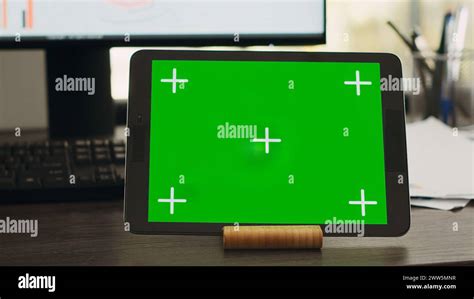 Empty Desk With Greenscreen On Tablet In Business Coworking Space