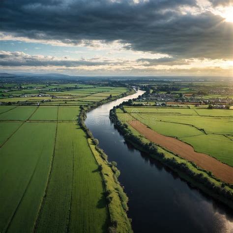 River Shannon Flows Between Green Grass Fields And Agriculture Land Irish Landscape Low Cloudy