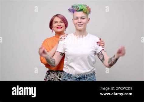 Two Young Girls With Bright Colored Dyed Hair And Short Haircuts