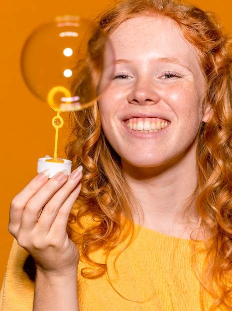 Free Photo Cute Woman Making A Soap Bubble