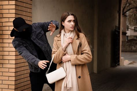Thief Trying To Steal Woman`s Bag In Alley Self Defense Concept Stock
