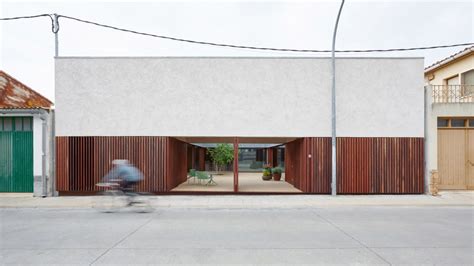 Paved Courtyard Hidden By Muted Facade Of Lr House In Spain