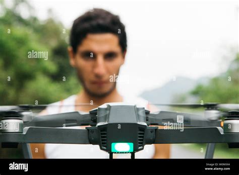 Close Up Flying Dron In Front Of A Blurred Concentrated Man Learning To