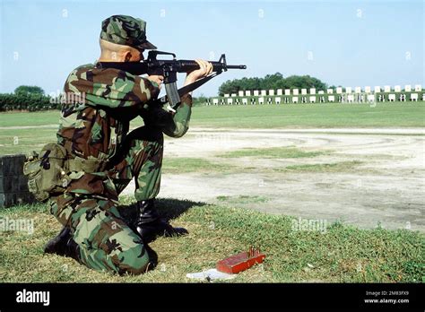 A Marine Recruit Fires An M 16a2 Rifle From A Kneeling Position During
