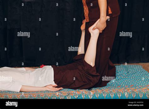 Thai Man Making Classical Thai Massage Procedure To Young Woman At