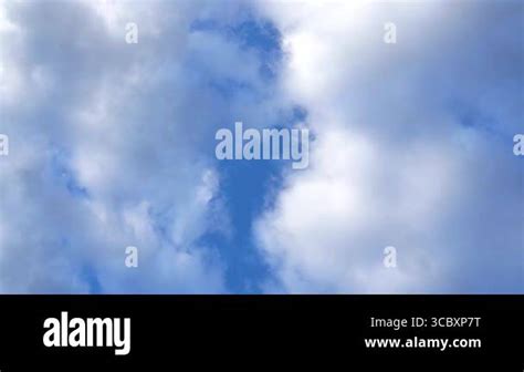 White Cumulus Clouds Move Rapidly Across A Clear Sky In A Daylight Time