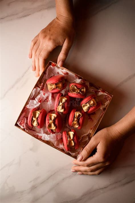 Confectionerand X27 S Female Hands Hold A T Box Covered With Pink Macaroons Decorated With Bow