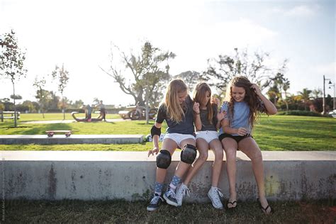 Friends And Cousins Playing Together On Skateboard Outside By Stocksy