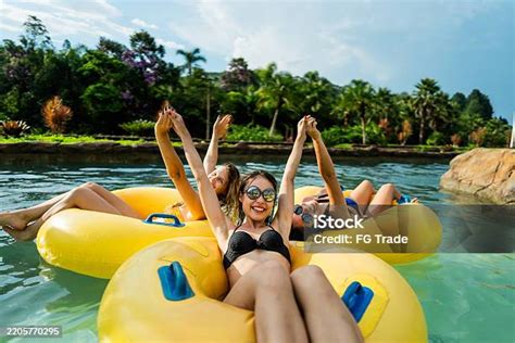 Portrait Of Friends On A Swimming Float In A Swimming Pool At A Water