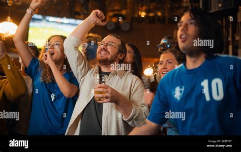 Soccer Club Members Cheering For Their Team Playing In An International Cup Final Supportive