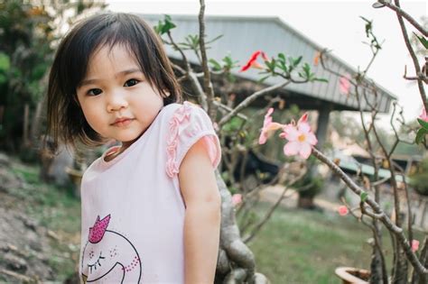 Premium Photo Portrait Of Cute Girl Standing Outdoors