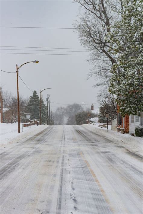 Road And Buildings Of A Small Town In The Suburbs Of Wshington Snow Covered Road And Houses Of
