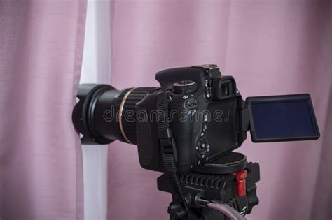 Digital Video Camera With Tilted Screen Hidden Behind Pink Curtains Spying Neighbors Peeping