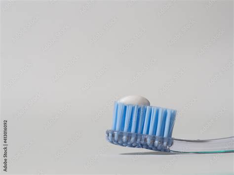 Toothbrush With Recommended Amount Of Toothpaste Equivalent To The Size