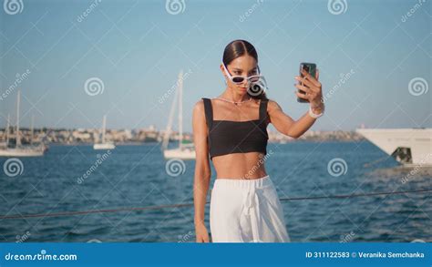 Lady Tourist Making Selfie On Smartphone At Sunny Waterfront Posh