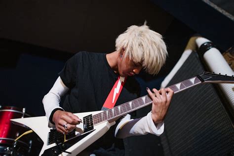 Low Angle Shot Of A Blond Haired Man Playing Electric Guitar · Free