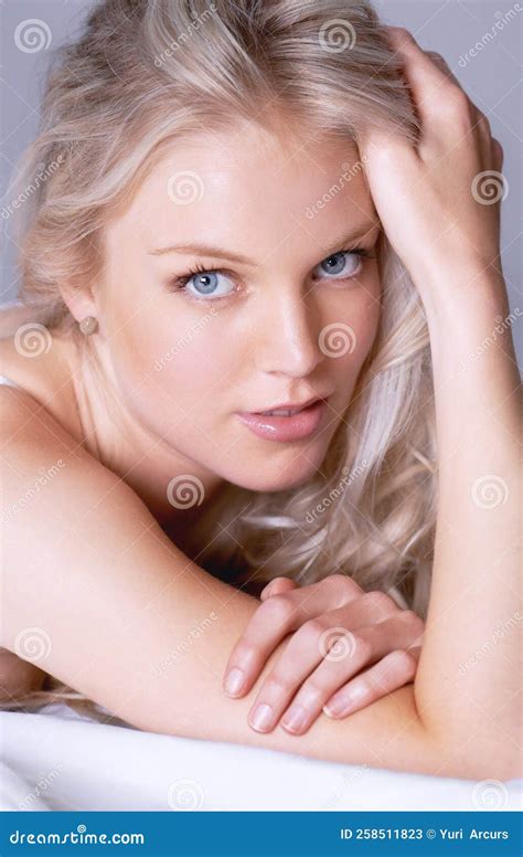 Sultry Siren Closeup Portrait Of A Gorgeous Young Blonde Woman Lying