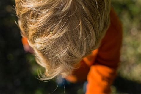 Premium Photo Boy Holding Rake In Yard