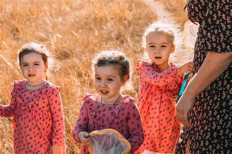 Premium Photo In The Heart Of Autumn Triplets Bond With Mom On A Net