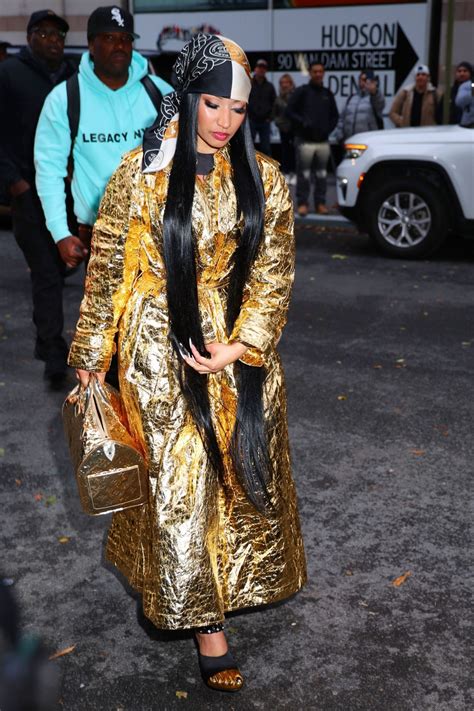 Nicki Minaj Wearing A Golden Dress And Golden Handbag In Nyc 12112023