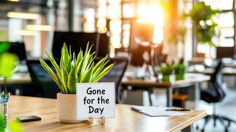A Neatly Organized Office Desk Featuring A Gone For The Day Sign