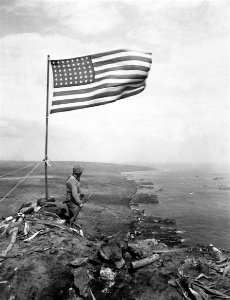 The Long Blue Line Hot Rocks”—a Coast Guardsman On The Beach At Iwo