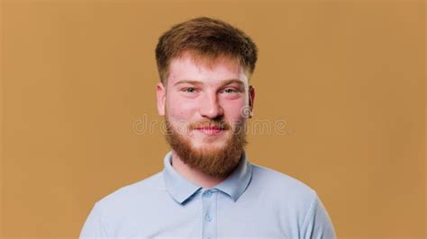 In The Studio A Handsome Redhead Teen Guy Leans Casually Against A