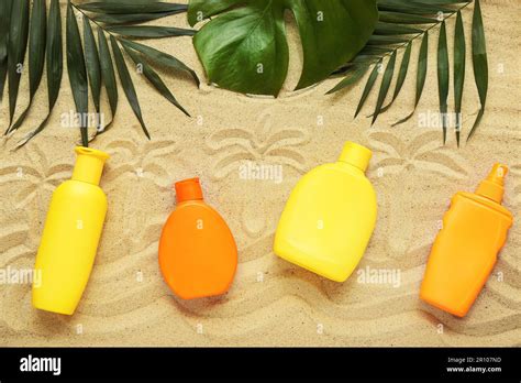 Creative Composition With Different Sunscreen Creams And Palm Leaves On