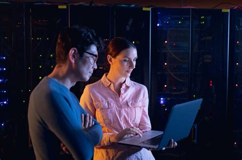 Premium Photo Diverse Male And Female Engineers Using Laptop In Computer Server Room Database