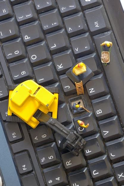 Premium Photo High Angle View Of Toy On Computer Keyboard