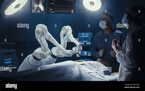 Two Surgeons Observing High Precision Programmable Automated Robot Arms