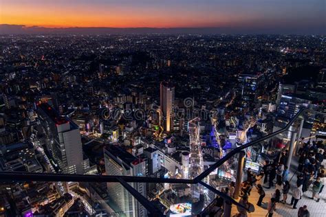 Shibuya Sky Observation Deck With Visitors Overlooking The Glowing City