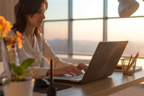 Side View Photo Of A Female Programmer Using Laptop Working Typing