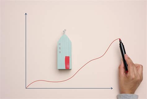 Premium Photo A Miniature Wooden House And A Womans Hand Draws A Graph With Growing Indicators