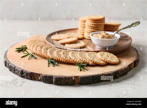 Plate With Tasty Crackers And Peanut Butter On Light Background Stock