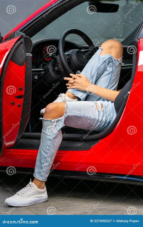 Red Car And A Girl In Blue Jeans Stock Image Image Of Happy Foot