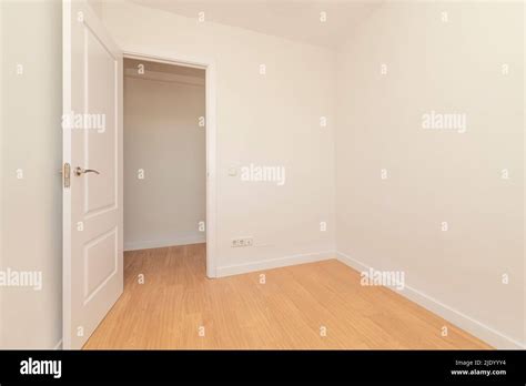 Empty Room With Light Oak Parquet Flooring Plain White Painted Walls