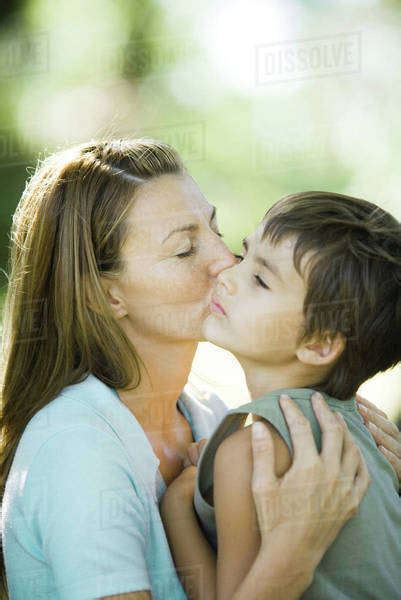 Mother And Son Woman Kissing Boy On Cheek Stock Photo Dissolve