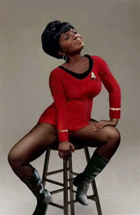 A Woman Sitting On Top Of A Stool Wearing Boots And A Red Shirt With Black Trim