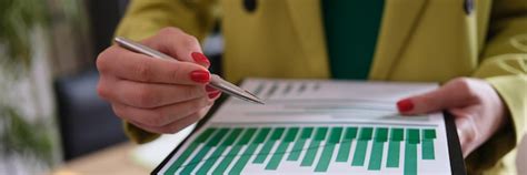 Premium Photo Businesswoman Holds Financial Report And Analytics In Charts Paper Document With