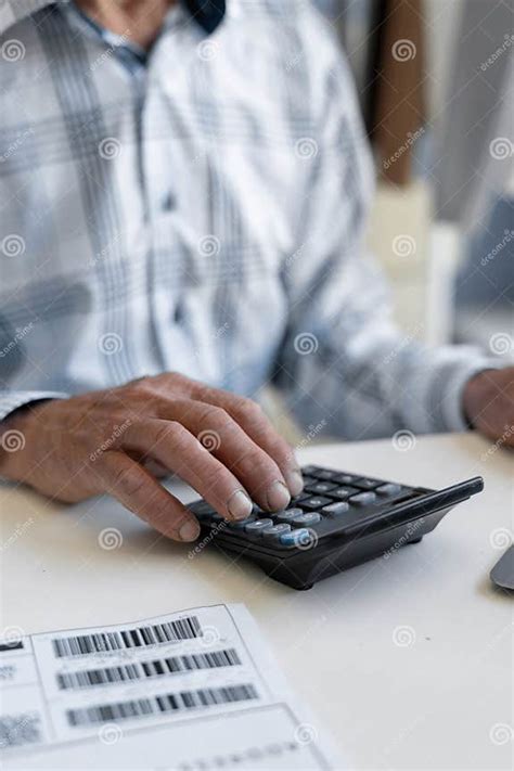 male salesman is an online store worker and uses calculator to