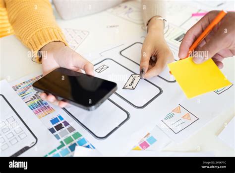 designers collaborating on ux ui mobile app wireframes and prototypes