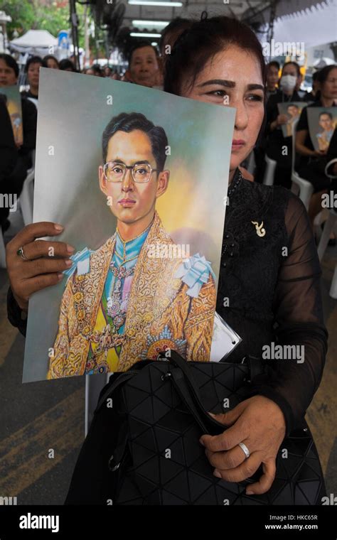 Women Holding Portraits Of The Late King Bhumibol Adulyadej Who Died At